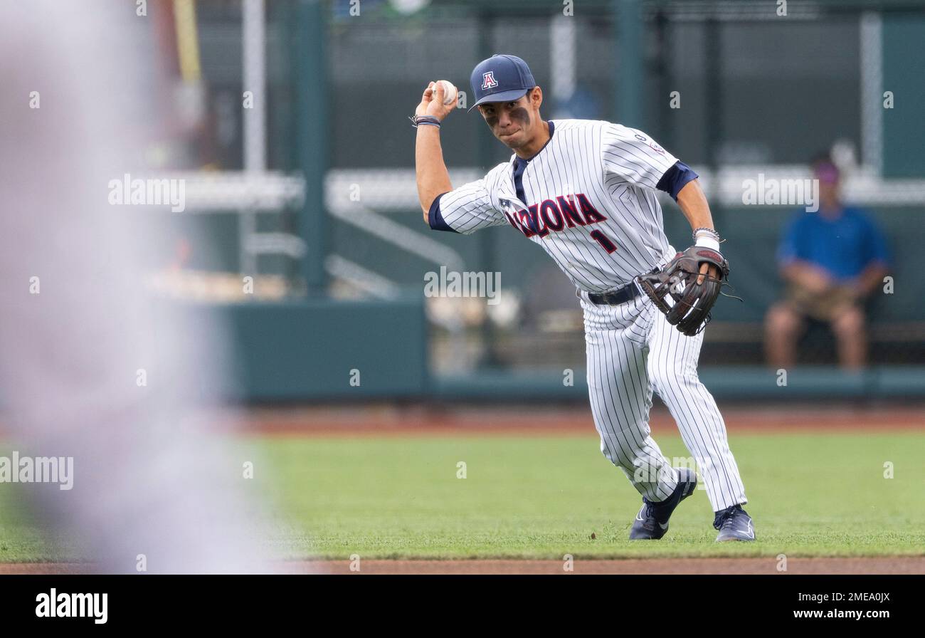 Arizona's Kobe Kato (1) fields a ball hit by Stanford's 44 in the first ...
