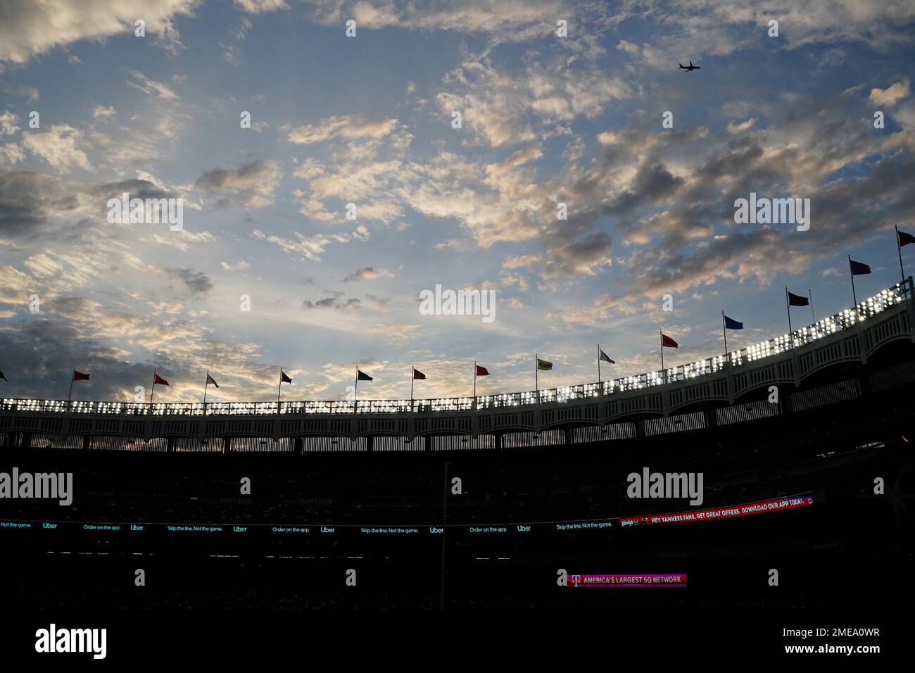 A plane passes over Yankee Stadium as the Oakland Athletics play the ...