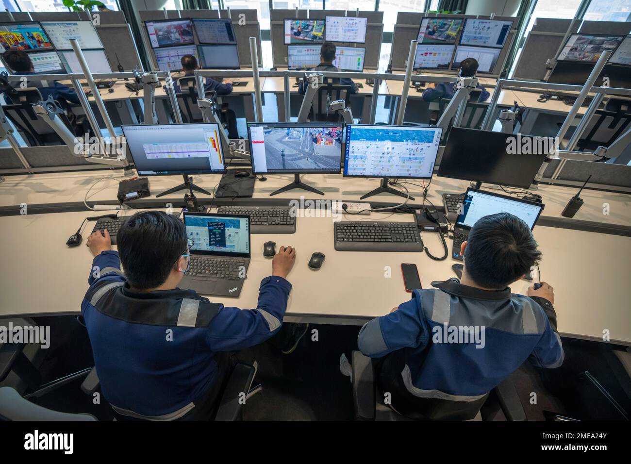 Workers use computer terminals to monitor remote operations at a ...