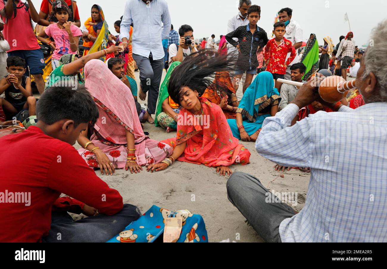 Priests perform exorcism on a Hindu devotees on the bank of Sangam, the ...