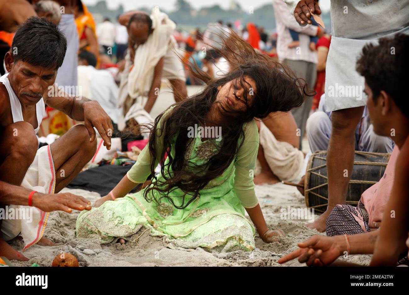 A priest performs exorcism on a Hindu devotee on the banks of the ...