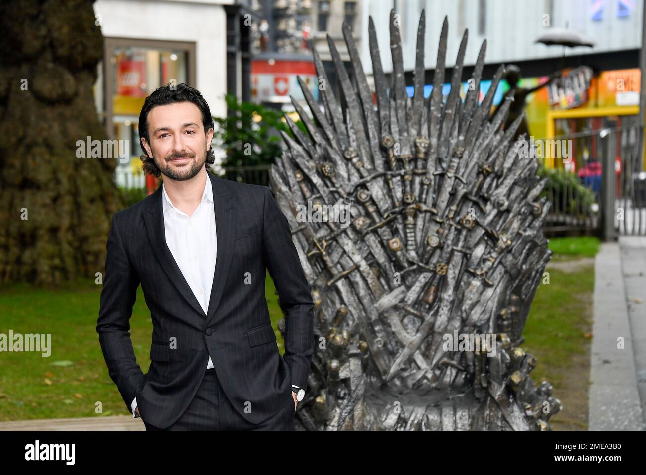 TV presenter Alex Zane poses next to the newly unveiled Game of Throne ...