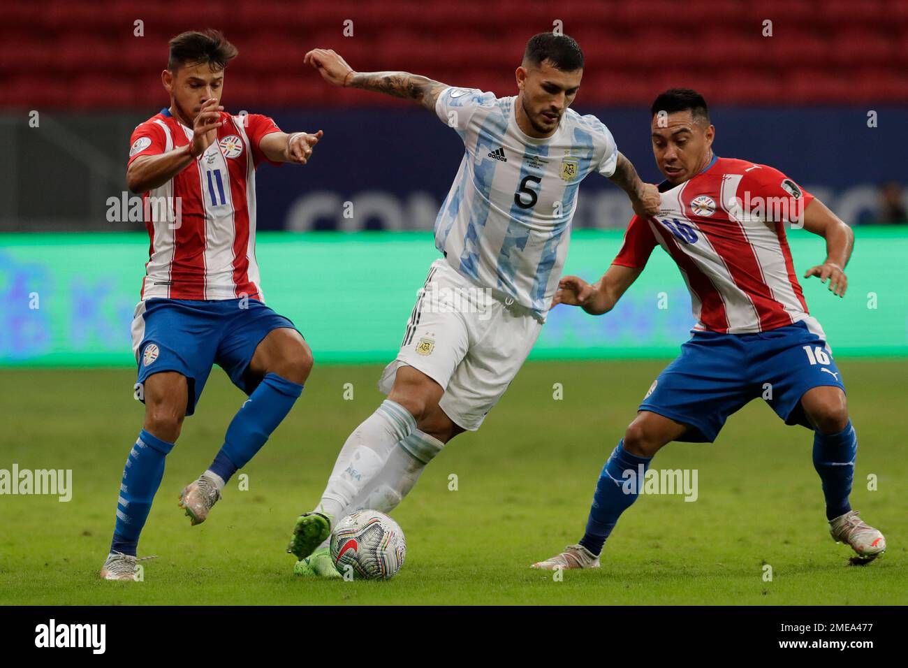 Argentina's Leandro Paredes, center, and Paraguay's Angel Cardozo ...