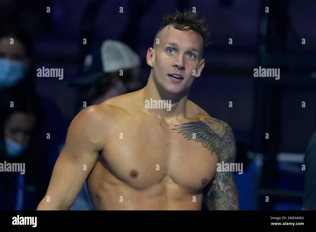 Caeleb Dressel walks on the pool deck after winning the men's 50-meter ...