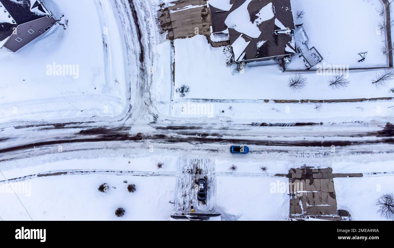 Aerial drone overhead view of a city street and plowed in residential ...