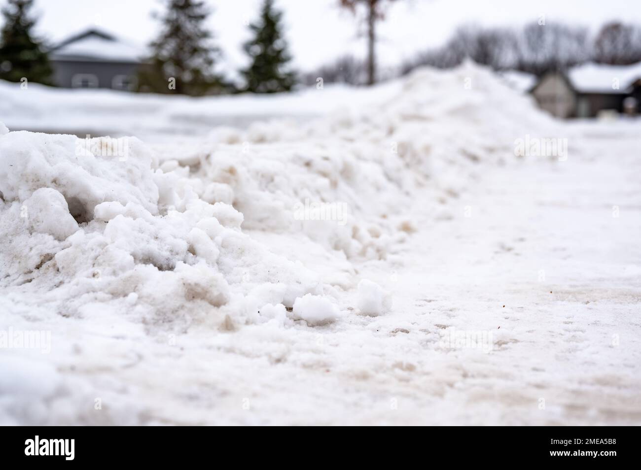 Snowbank at the end of a driveway left after city snowplows cleared a ...