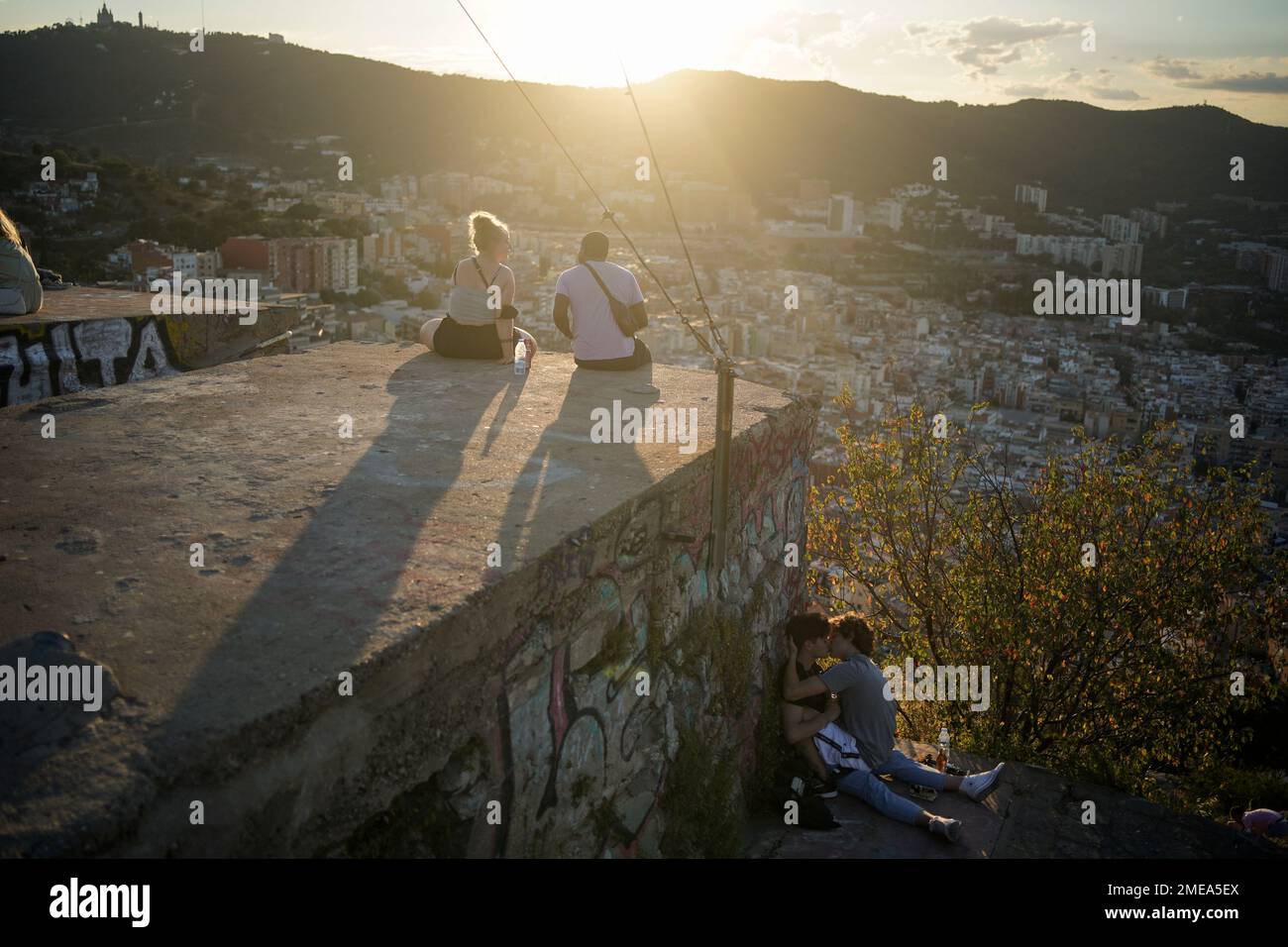 A couple kiss at a panoramic vantage point overlooking the city of ...