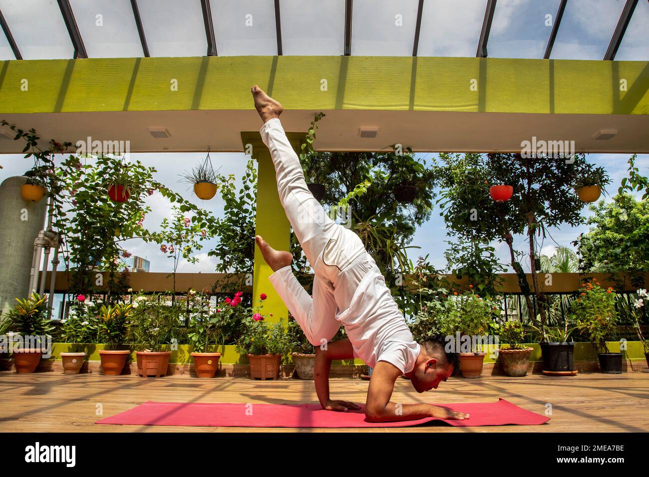 An Indian man performs yoga to mark International Yoga Day in Gauhati ...