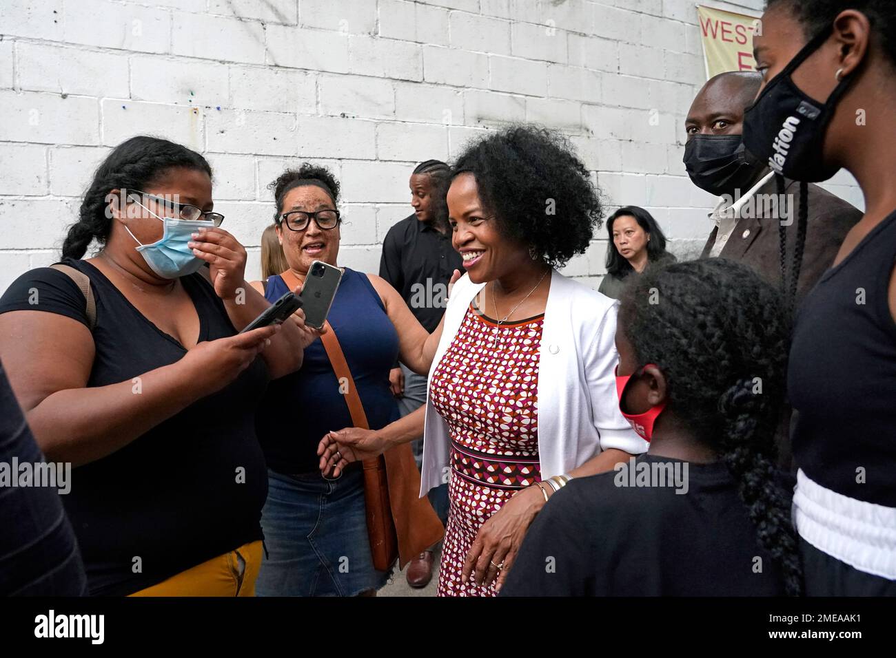 Boston's acting Mayor Kim Janey, center, mingles with attendees in ...