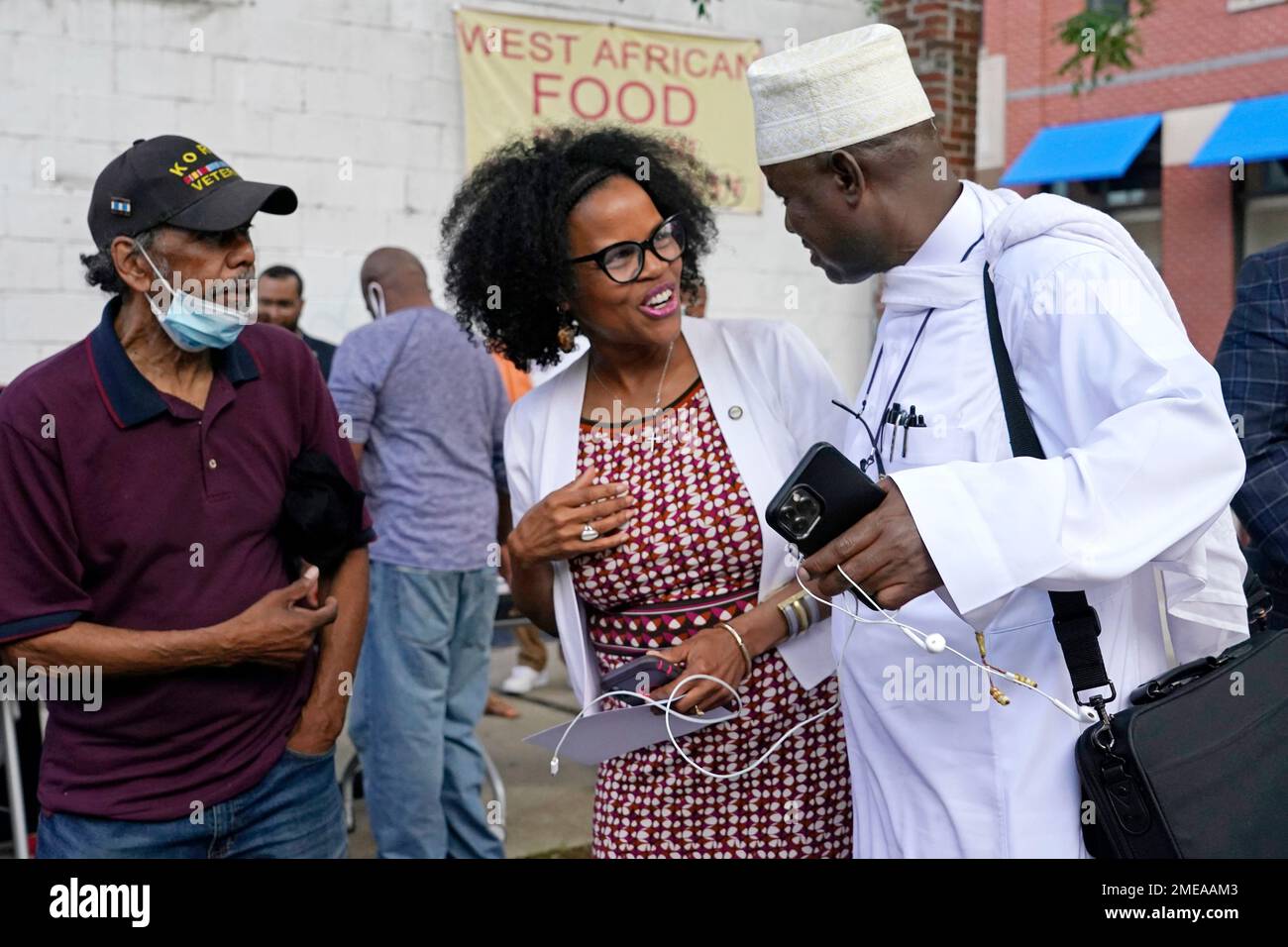 Boston's acting Mayor Kim Janey, middle, greets attendee Mahdi Ali ...
