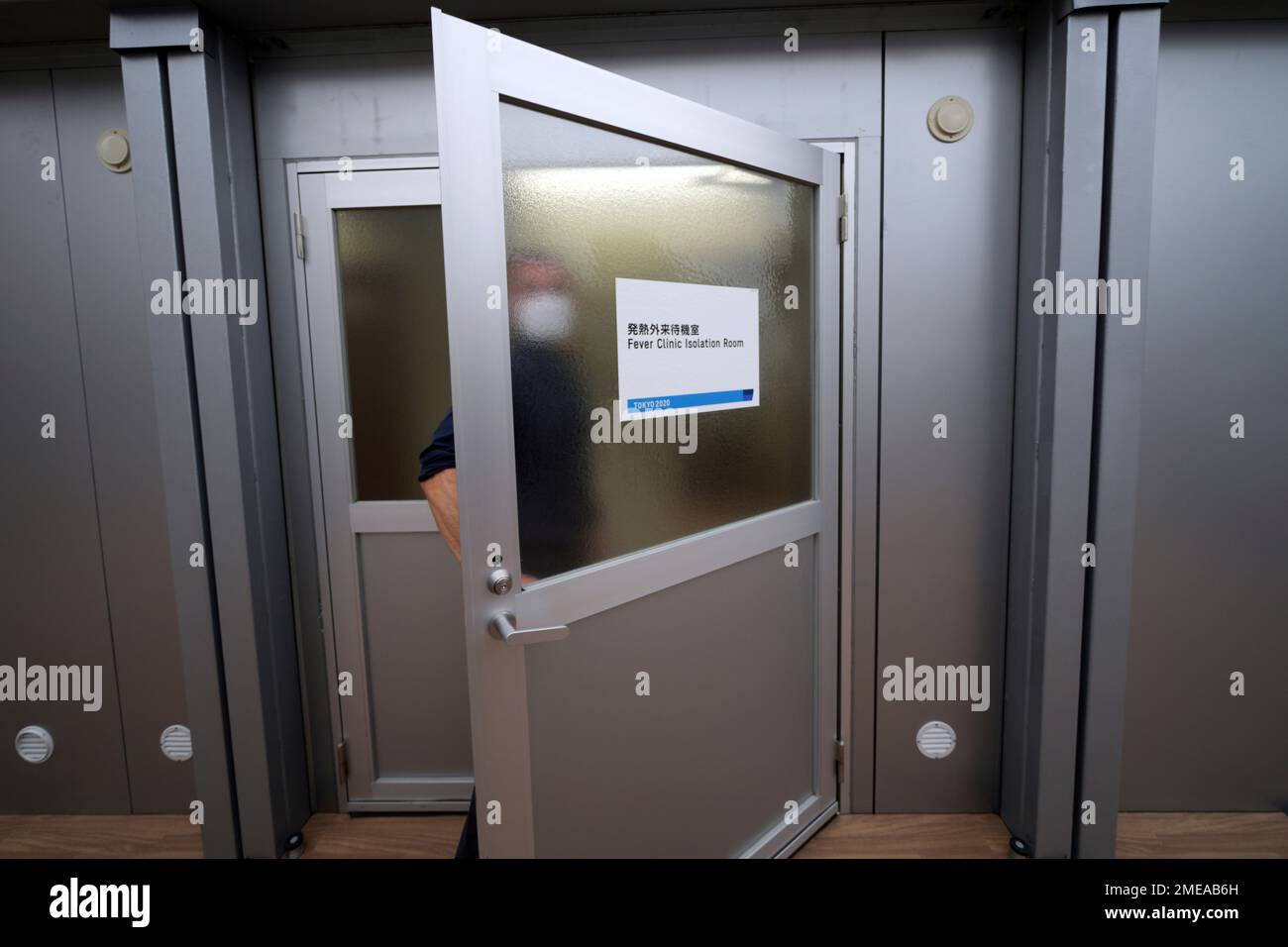 A journalist opens the door of a fever clinic isolation room at Tokyo ...