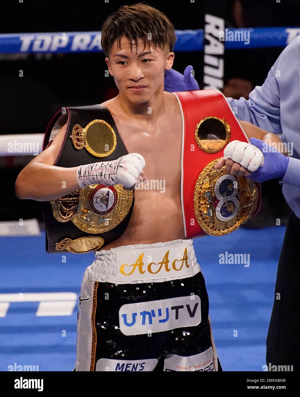 Naoya Inoue, of Japan, holds up his belts after defeating Michael ...