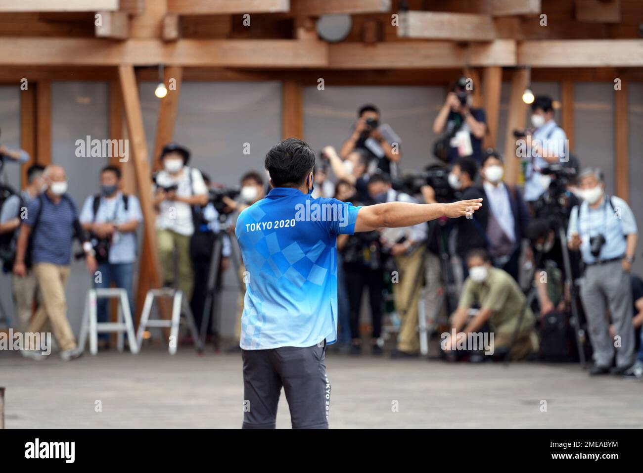 A staff of Tokyo 2020 Olympic and Paralympic guides media personnel at ...