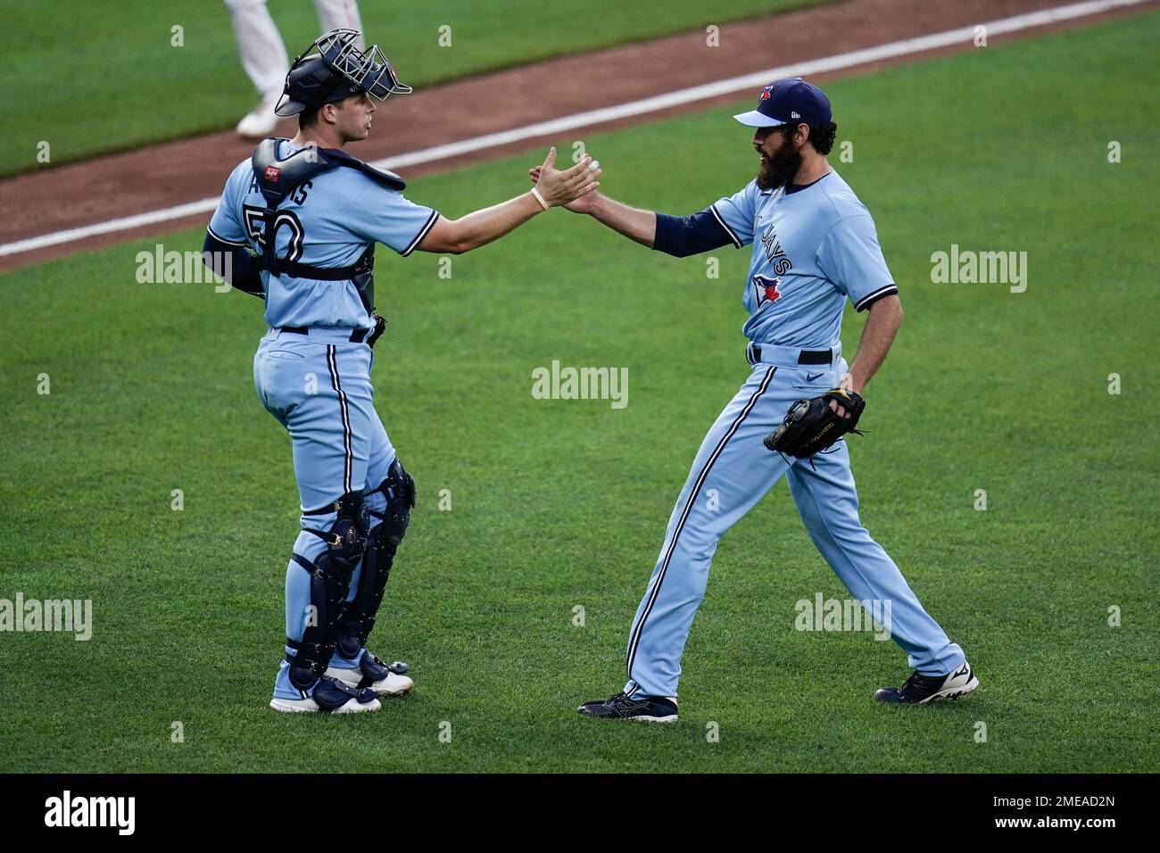 Toronto Blue Jays catcher Riley Adams, left, and relief pitcher Jordan ...