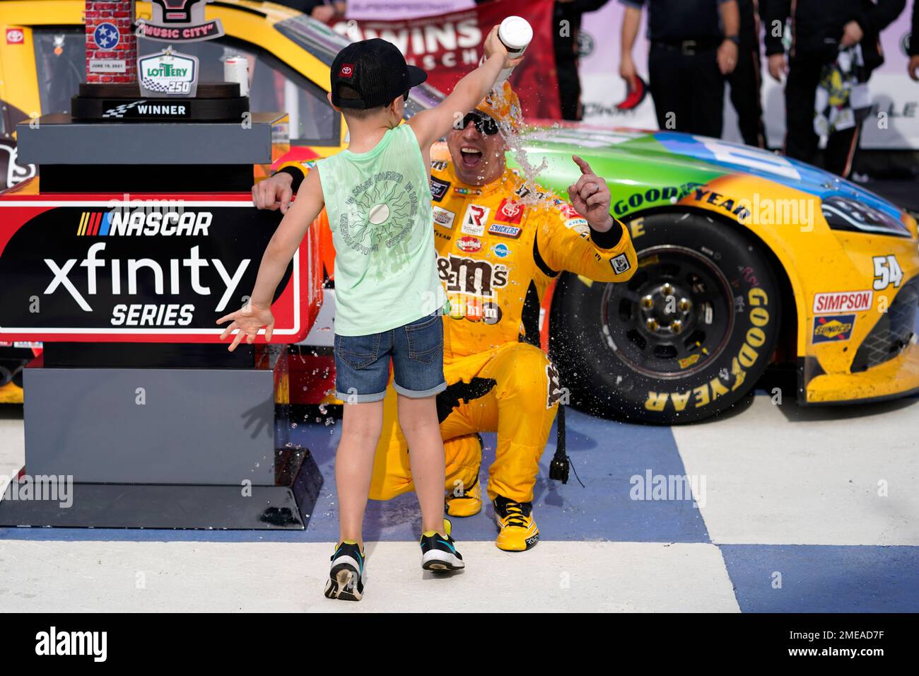 Kyle Busch has water poured on him by his son, Brexton, after winning a ...