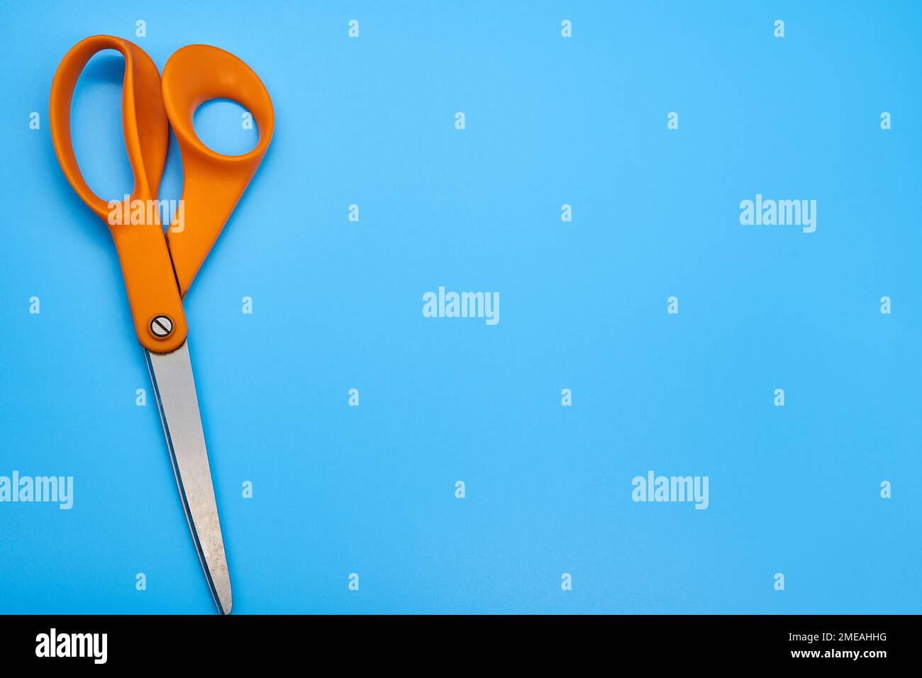 Orange shear scissors on a light blue background cutting shears baby ...