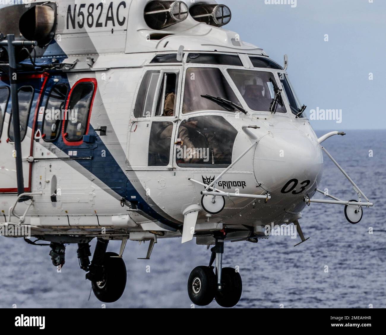 A pilot with the Maritime Pre-Positioning Force flies an EC-255 Super Puma with the Maritime Pre ...