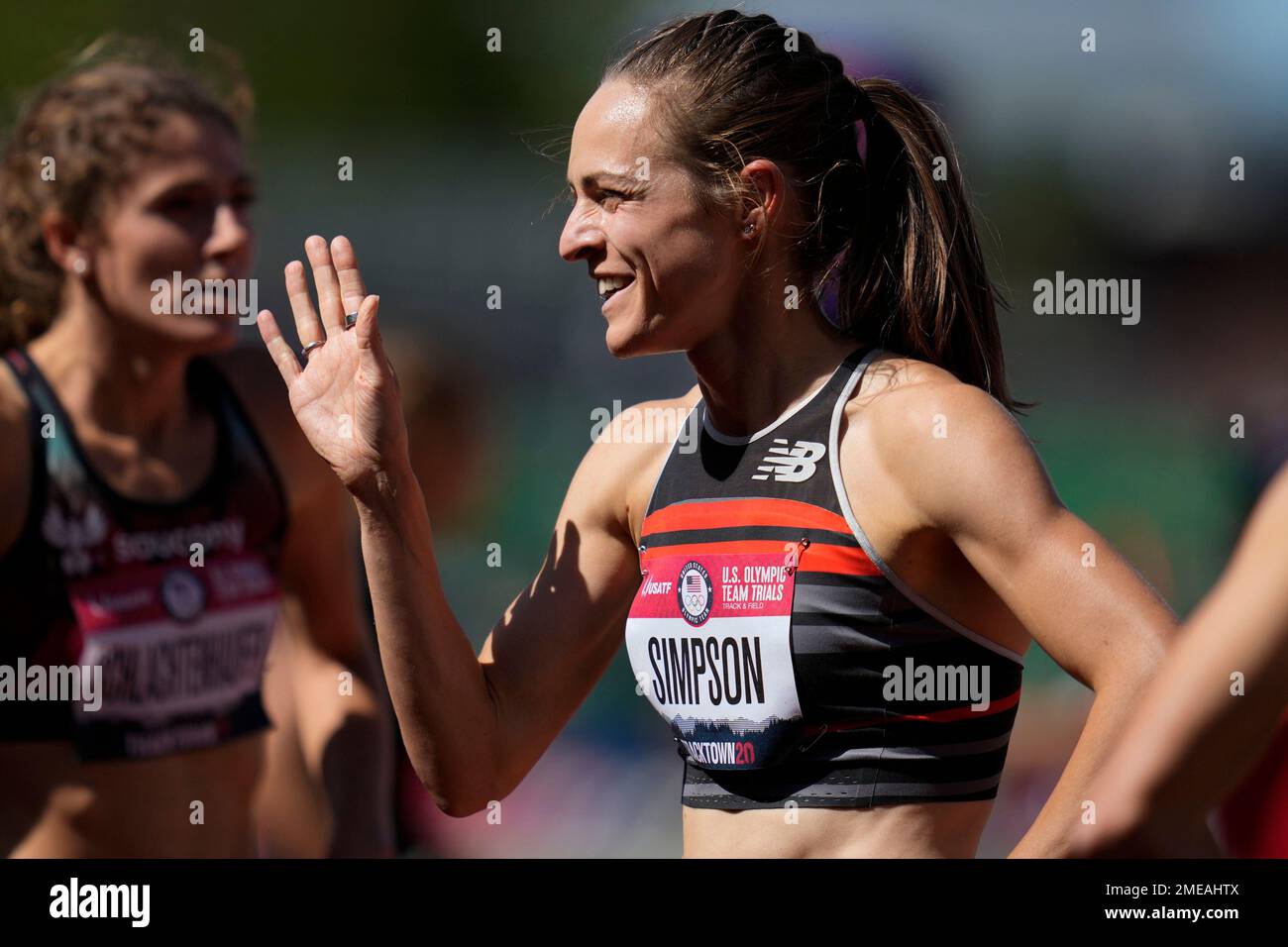 Jenny Simpson, right, celebrates after winning the first heat in the ...