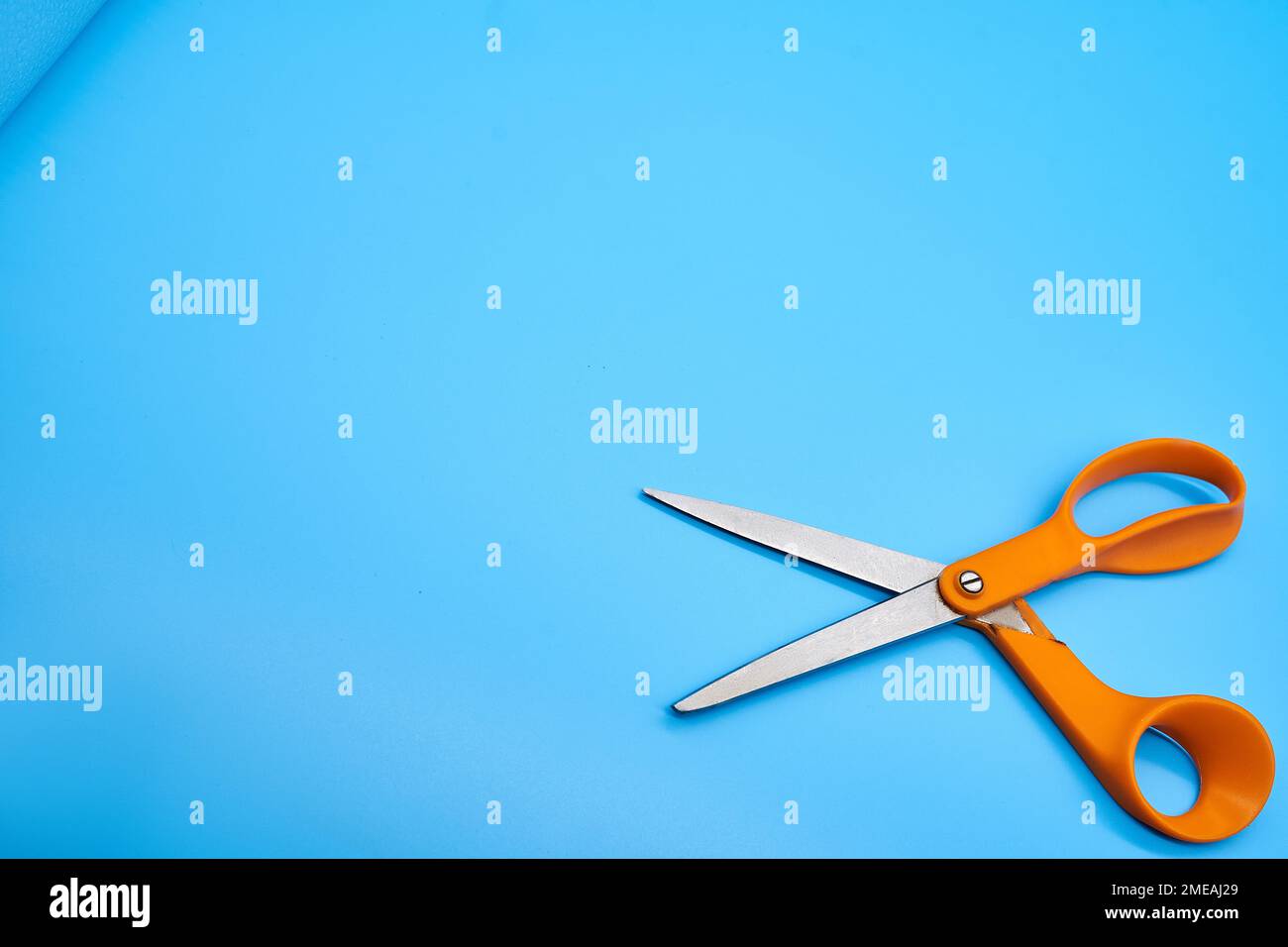 Orange shear scissors on a light blue background cutting shears baby ...