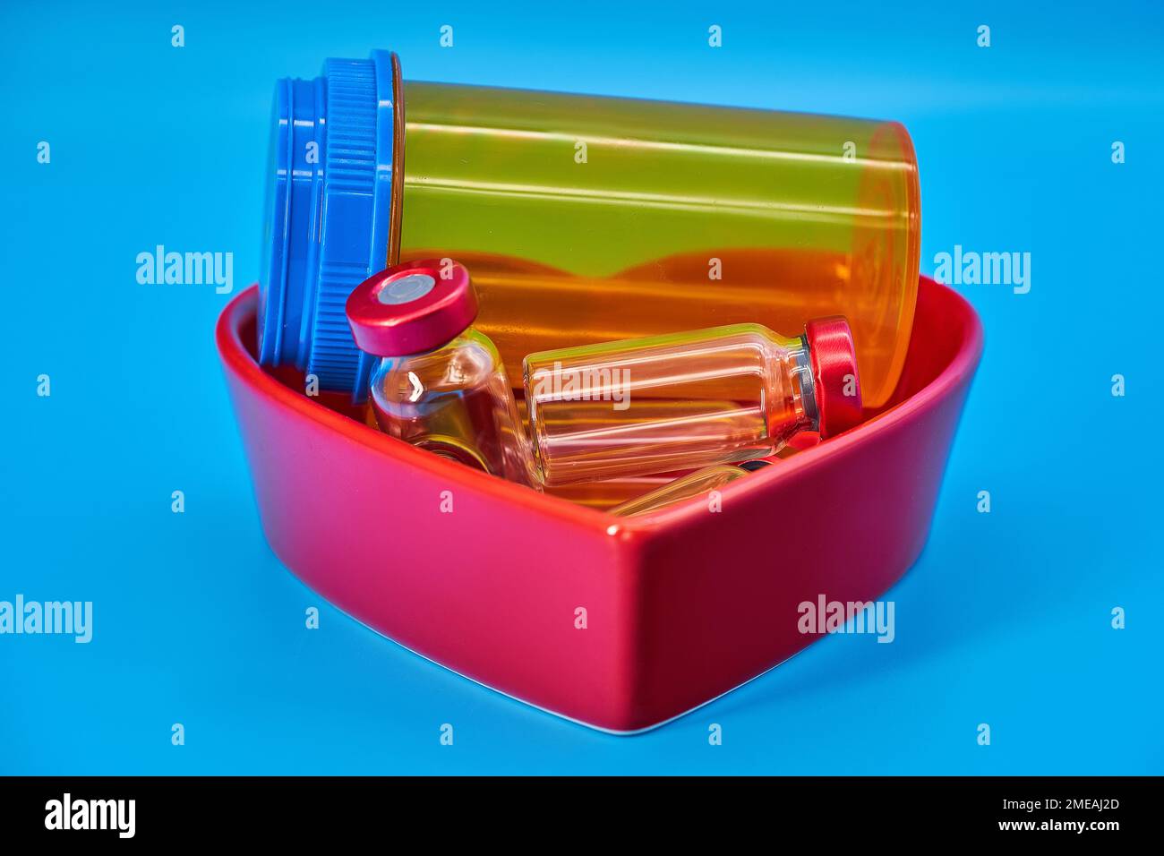 Medical gloves and vials on blue background for needle injection ...