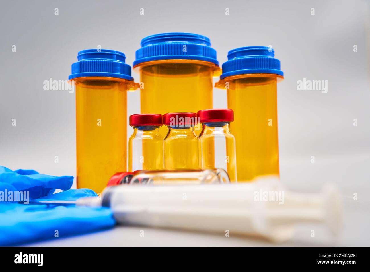 Medical gloves and vials on grey background for needle injection ...