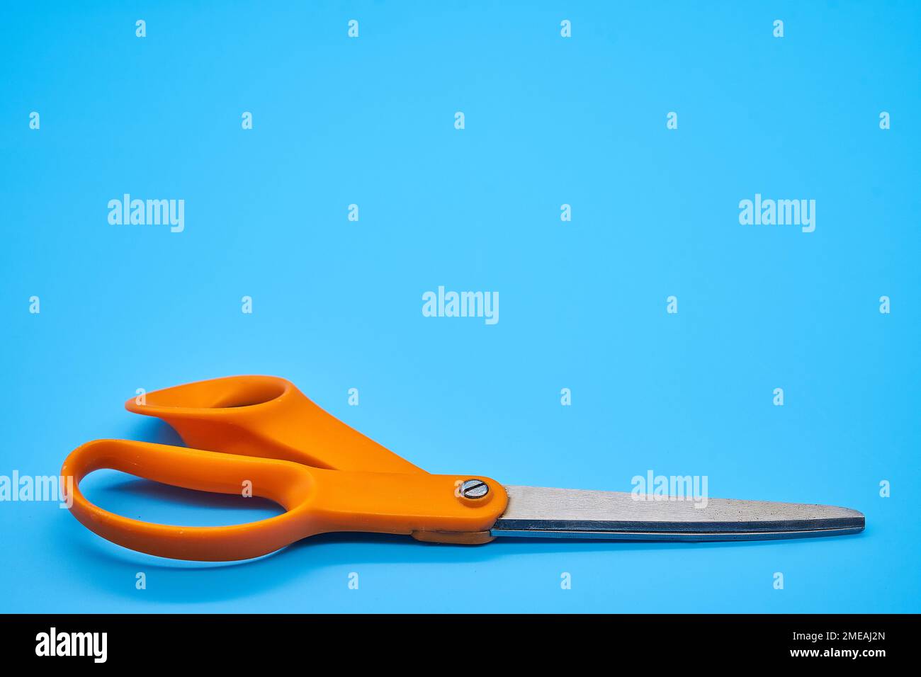 Orange shear scissors on a light blue background cutting shears baby ...