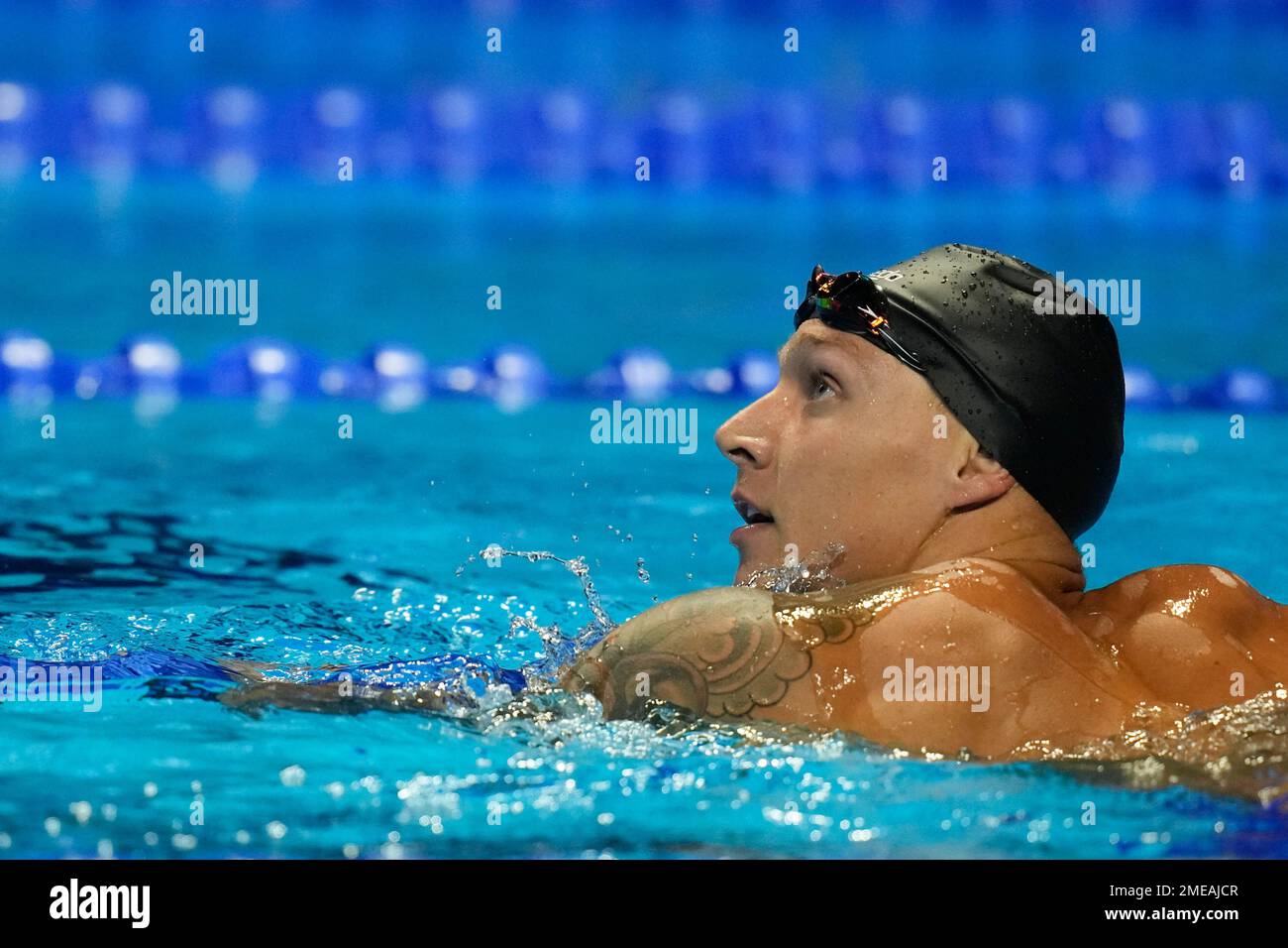 Caeleb Dressel checks his time after winning the men's 100-meter ...