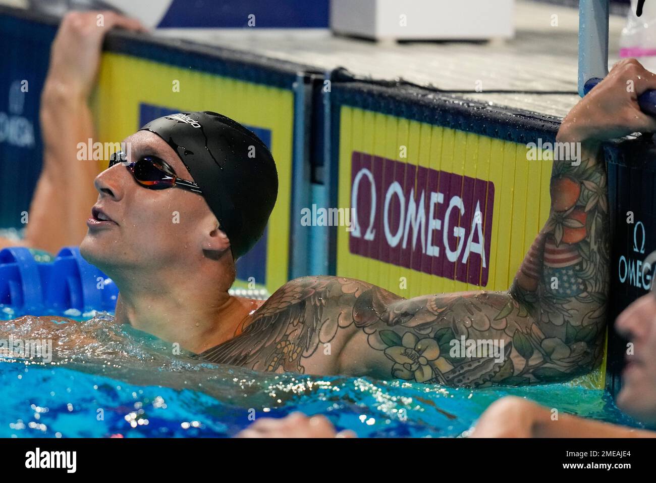 Caeleb Dressel checks his time after winning the men's 100-meter ...