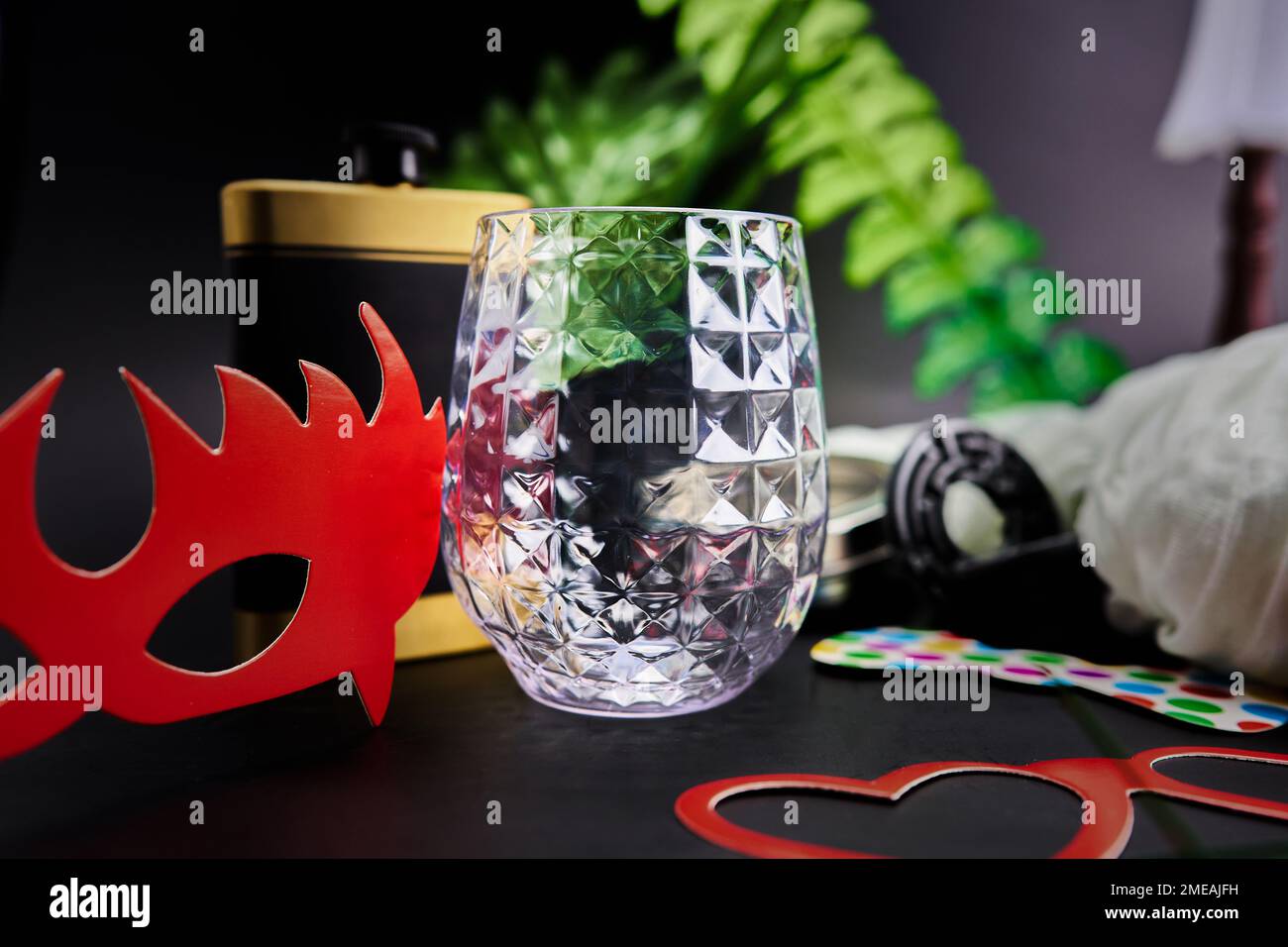 whiskey glass with flask on a black background metal maze puzzle leaves ...