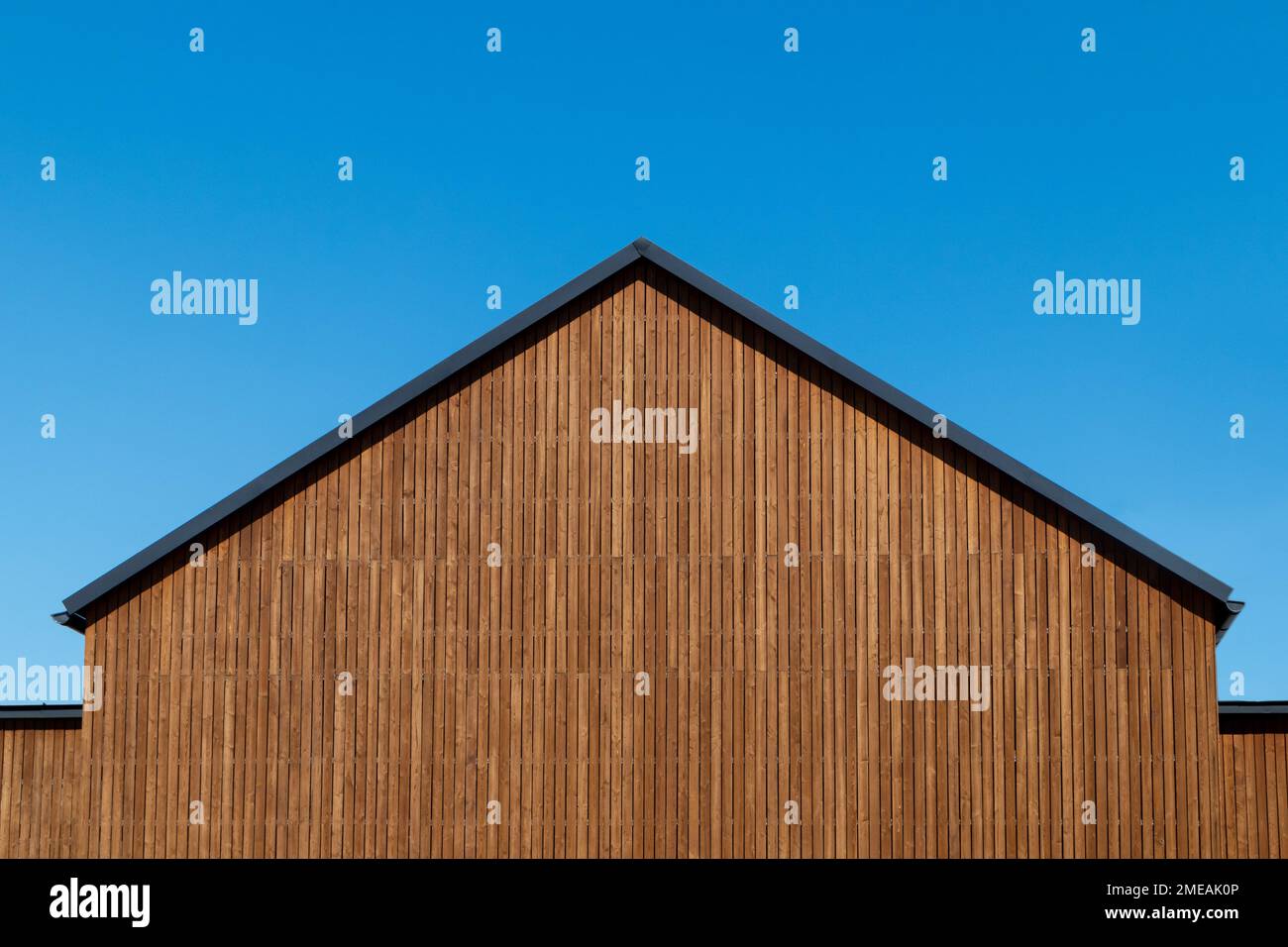 Facade decoration of the roof gable with natural wood plank of a new ...