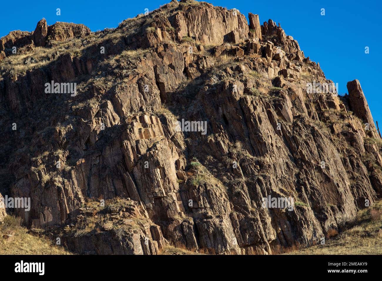 Big Rocky stone under blue sky background Stock Photo - Alamy