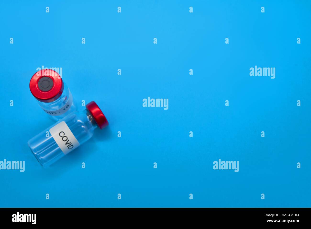Medical Covid-19 Vaccine vials on blue background for needle injection ...