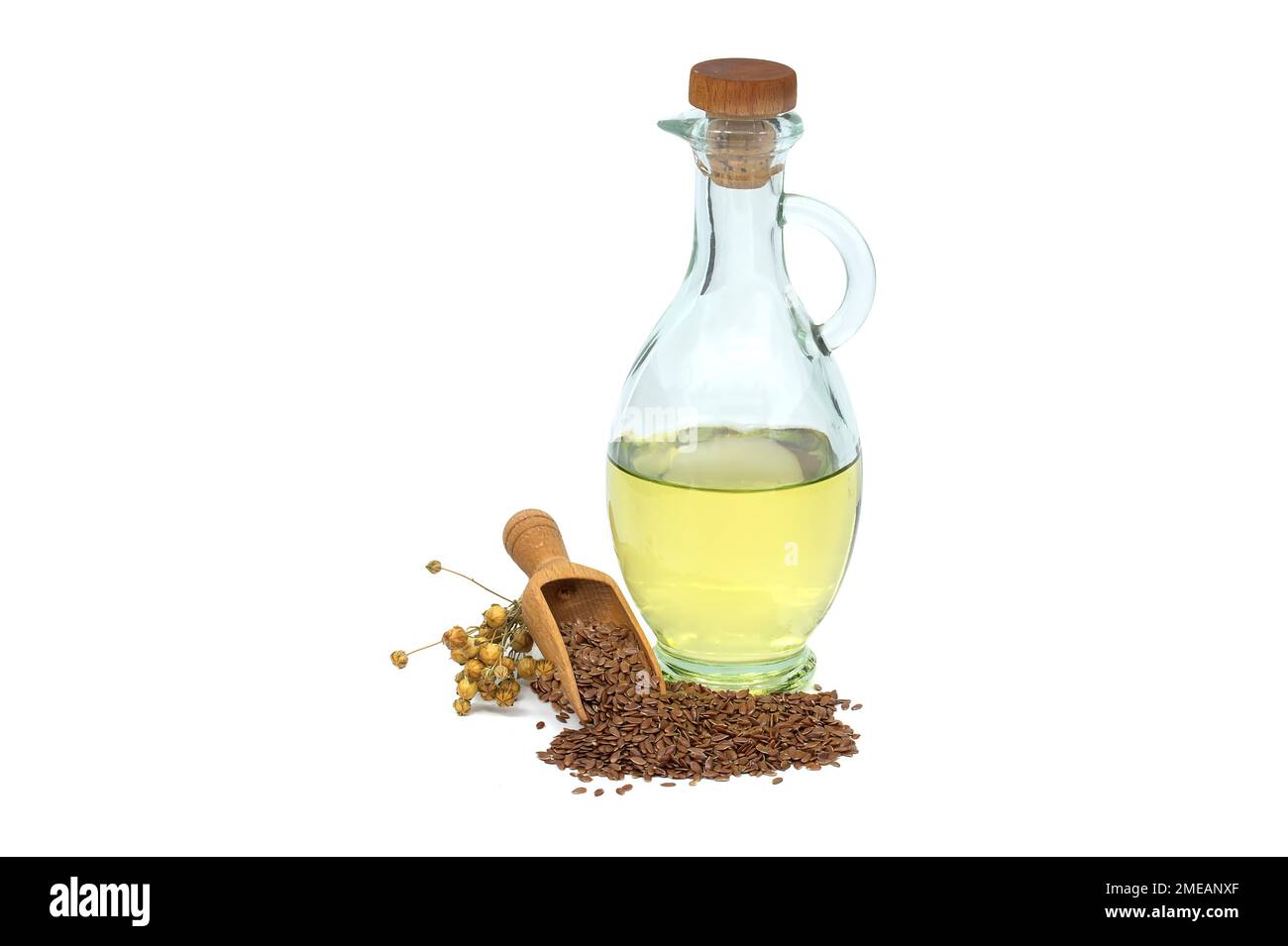 Linseed oil in glass decanter and linseed in wooden scoop near bunch of flax plants isolated on ...