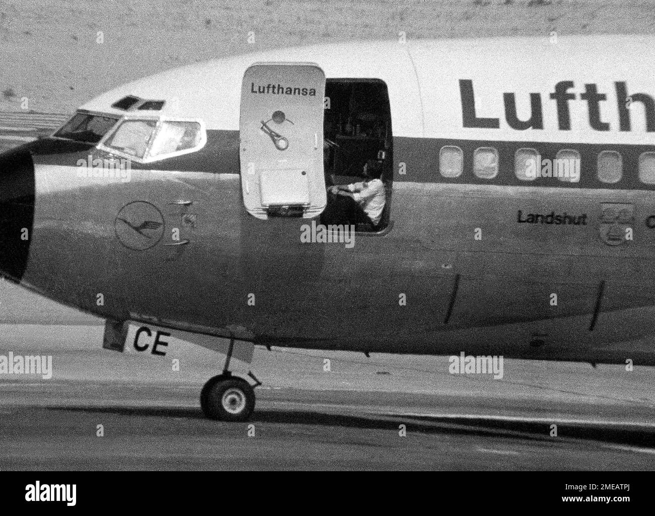 A crewman identified as pilot Juergen Schumann is threatened with a ...