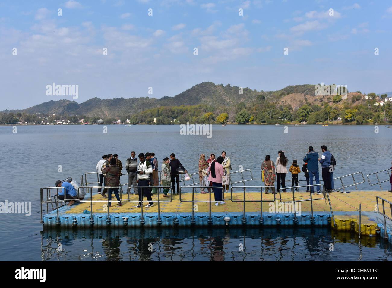 Mansar Lake, India. 24th Jan, 2023. Visitors walk on the jetty as they explore the Mansar lake ...