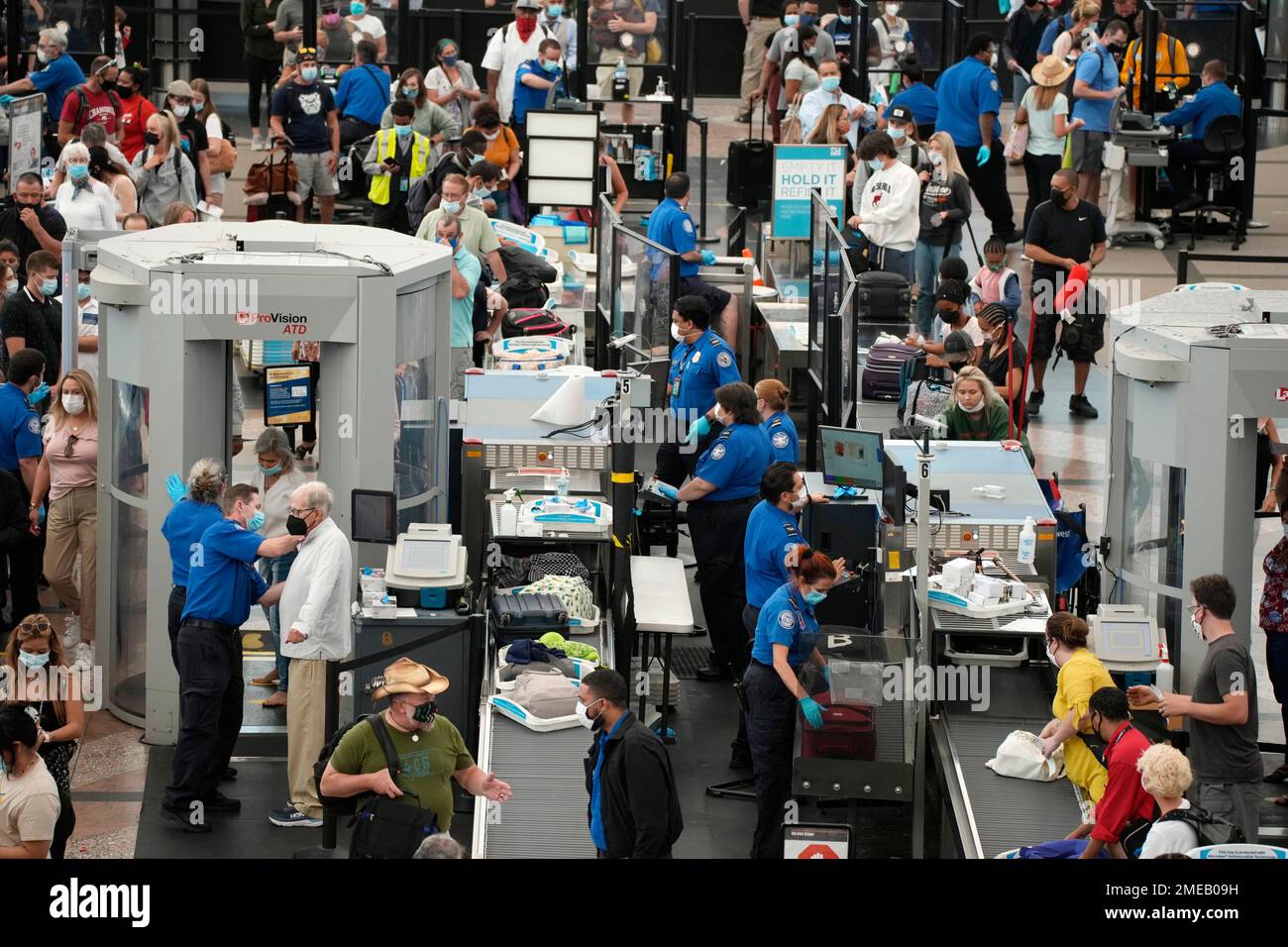 Travelers queue up in long lines to pass through the south security ...