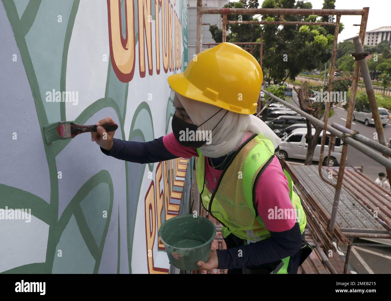 Indonesian artist Lakeisha makes finishing touches to a large gender ...