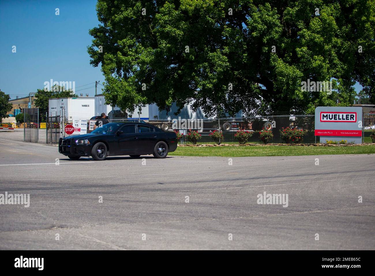 A police car guards the entrance to a Mueller Co. fire hydrant plant where police said multiple ...