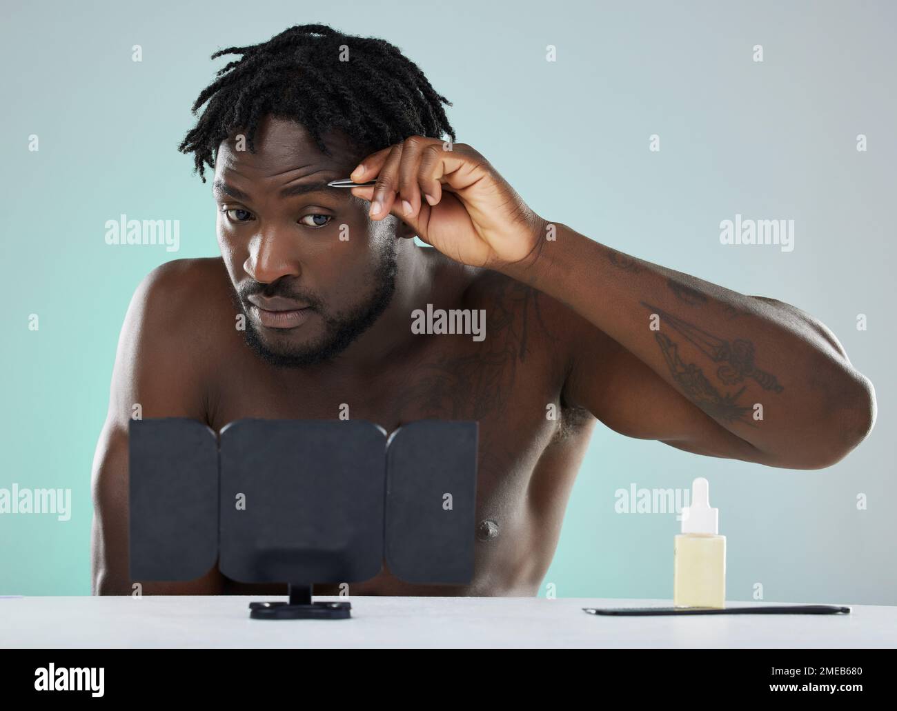 Back man, tweezer and eyebrows in studio with face, mirror and beauty ...