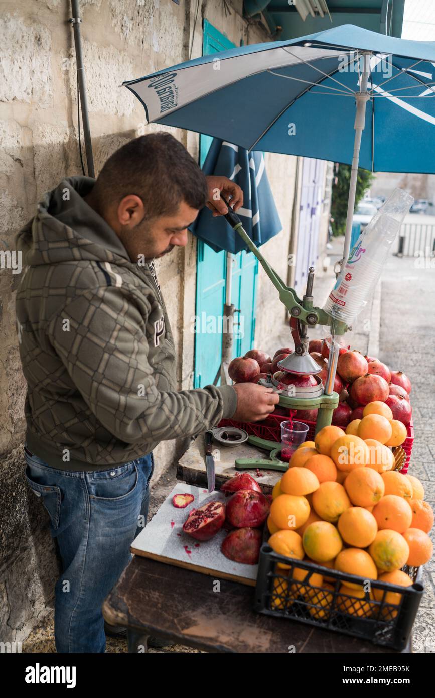 Street scene with man making pomegranade juice in the Betlehem, Israel ...