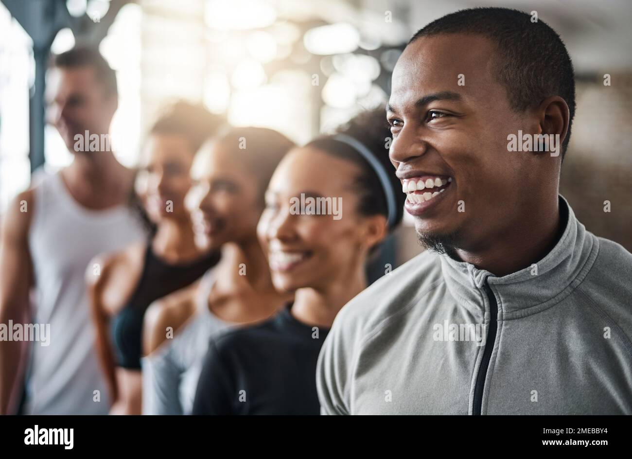 First in line for fitness. a group of young people standing together in ...