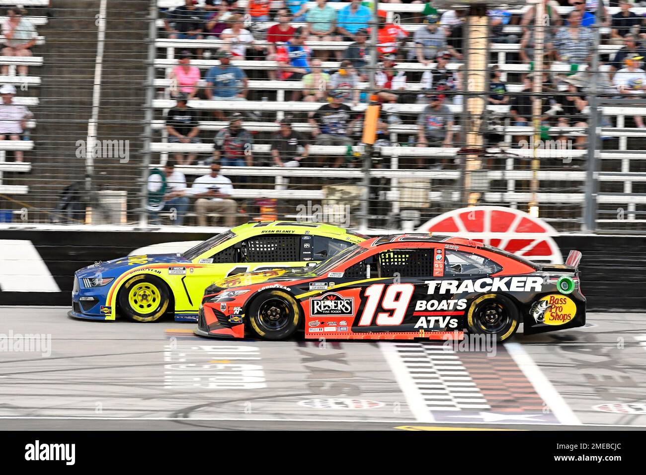 Martin Truex Jr. (19) and Ryan Blaney, rear, compete on the front ...