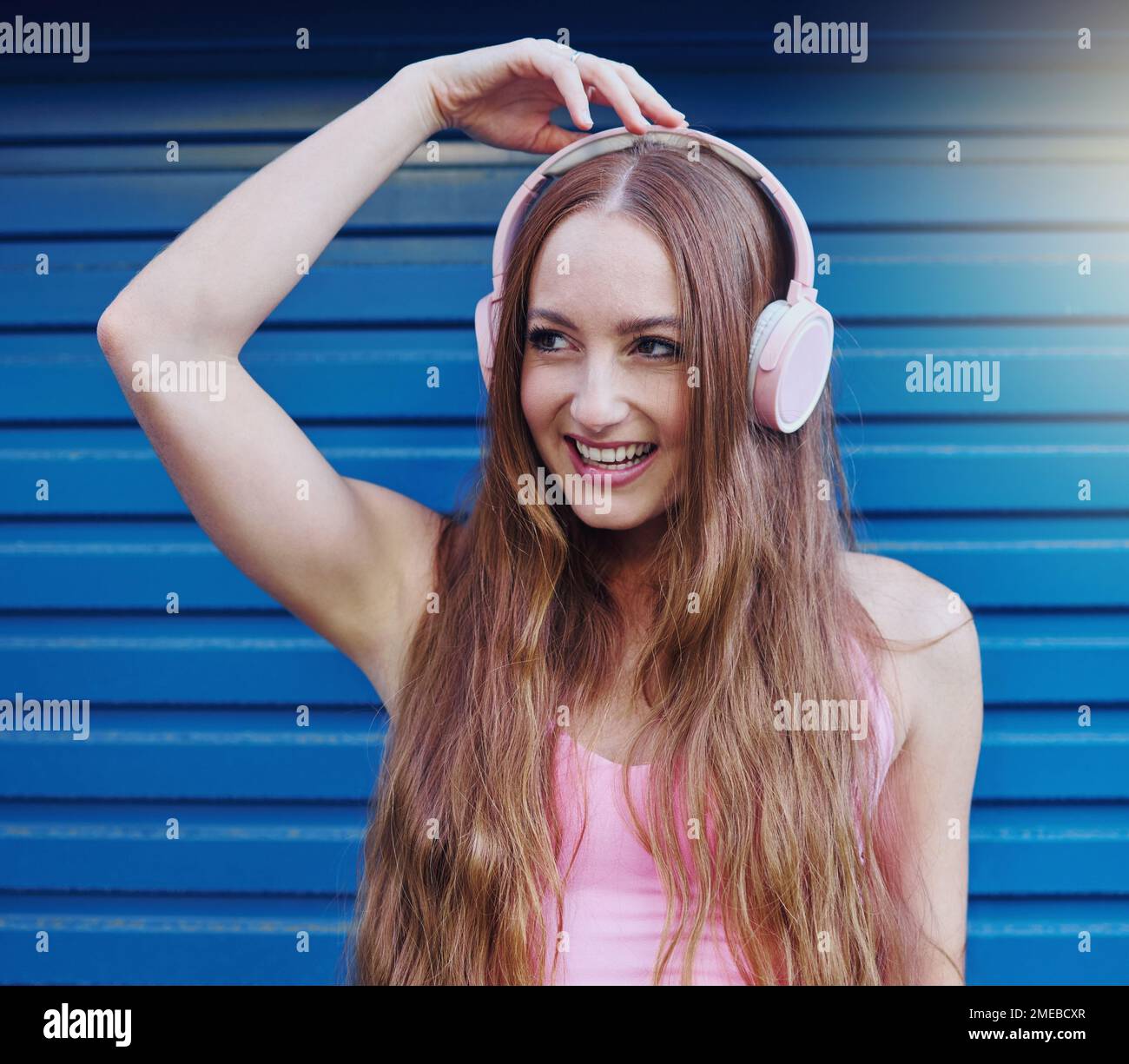 Music, headphones and blue background with a woman listening to or ...