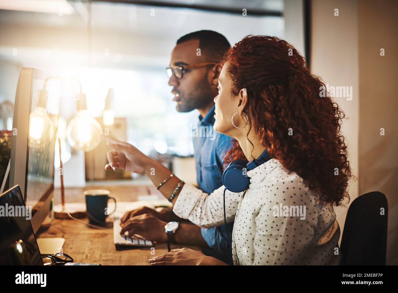 Late night teamwork in action. a young businessman and businesswoman ...