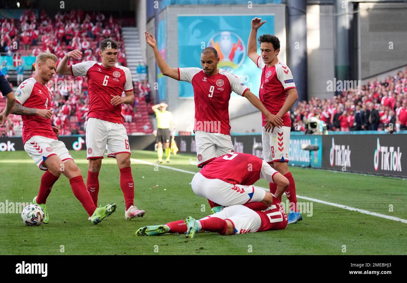 Denmark players run to Denmark's Christian Eriksen fallen on the ground ...