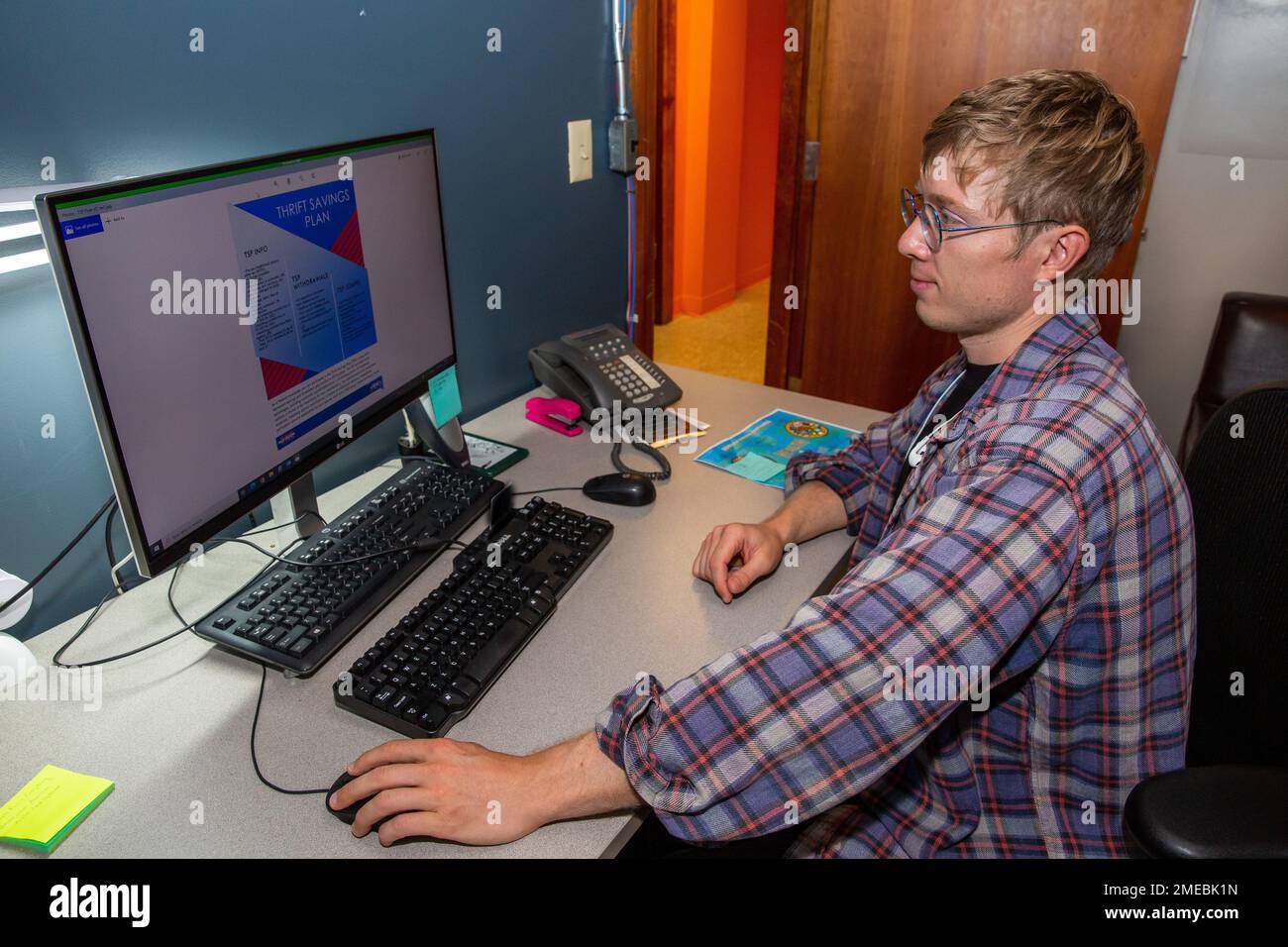 Visual Information Specialist Cole Fraser works on a graphic design ...