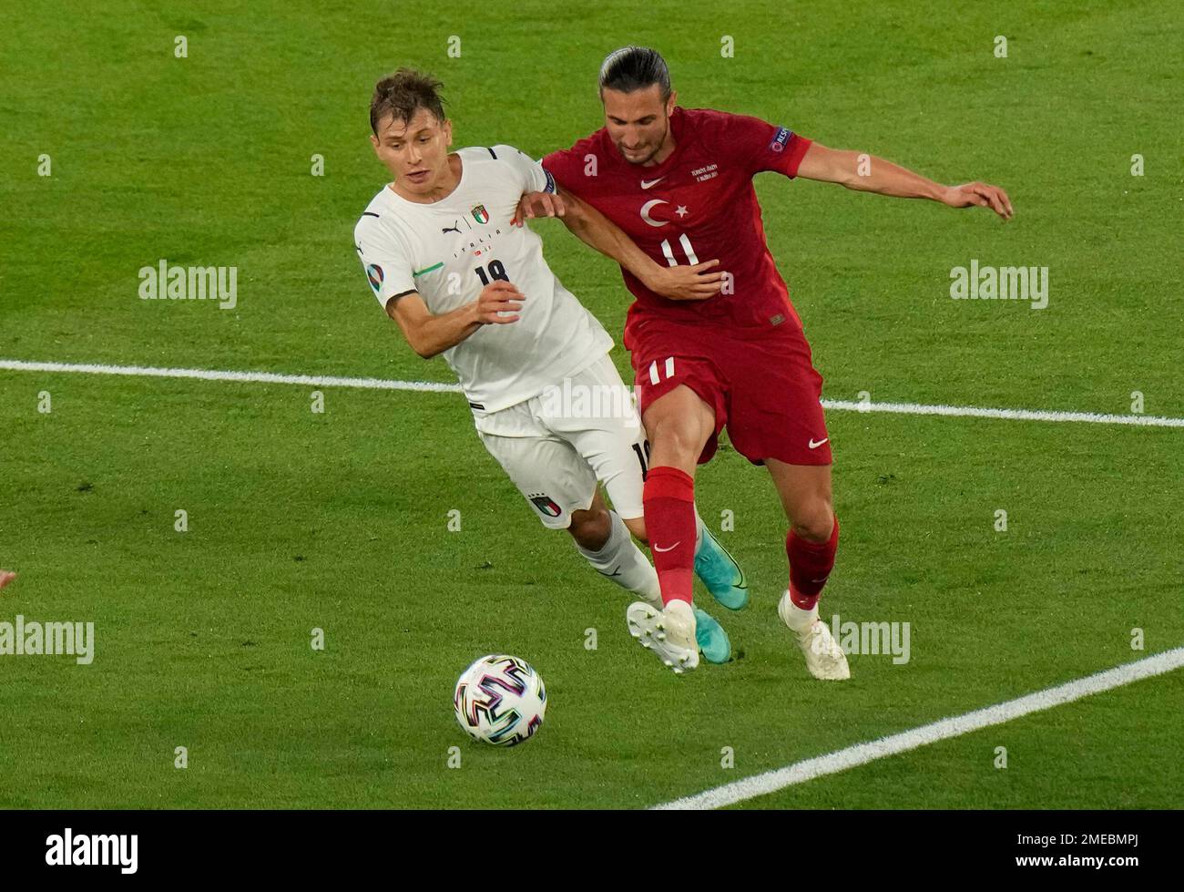 Italy's Nicolo Barella, left, challenges for the ball with Turkey's ...
