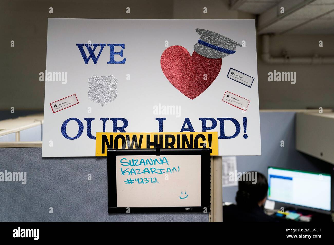 In this Sept. 9, 2020, photo a "Now Hiring" sign is placed on a cubicle ...