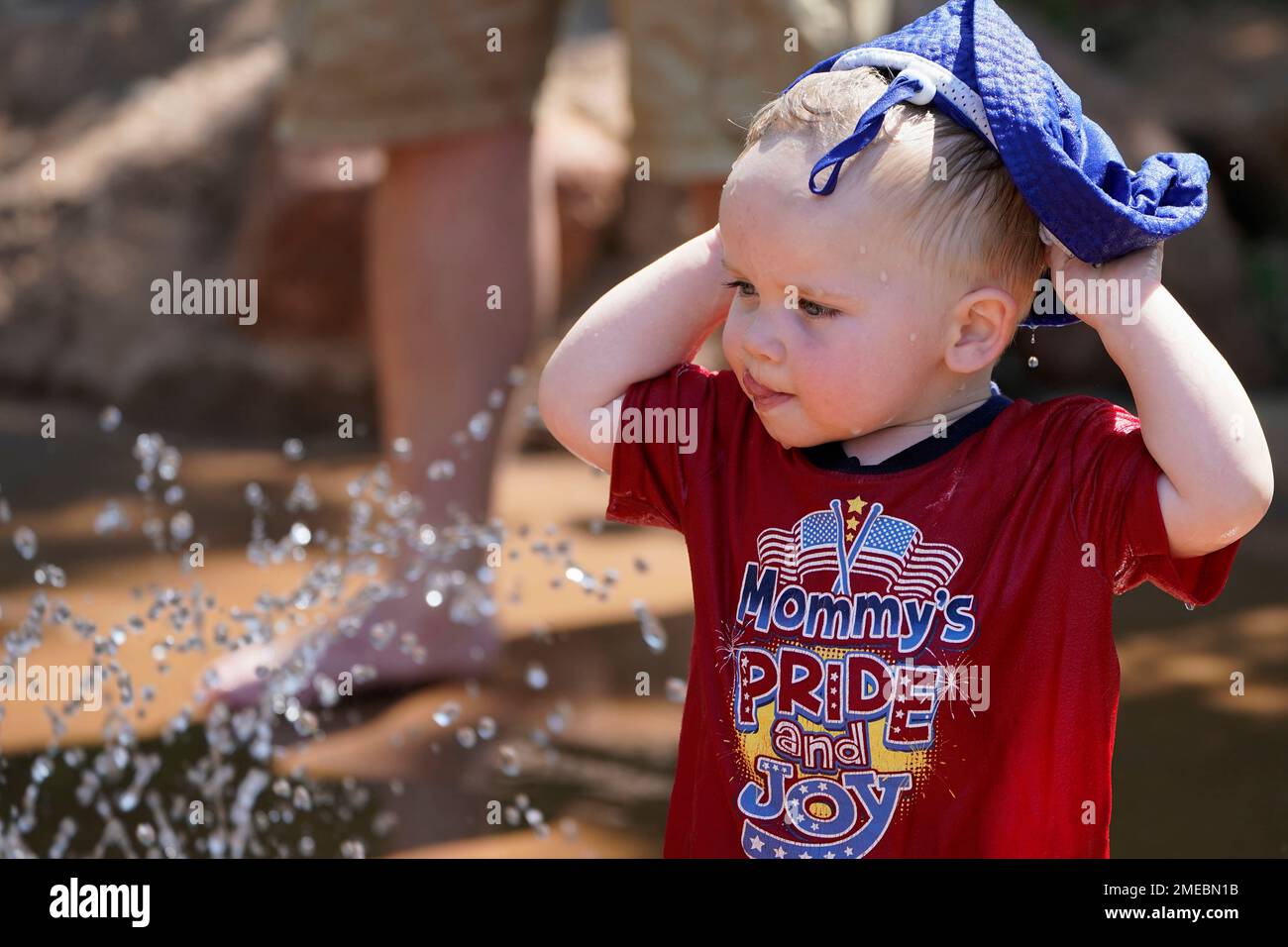 One-year-old Calvin Cunningham, from Perry, Okla., plays in the water ...