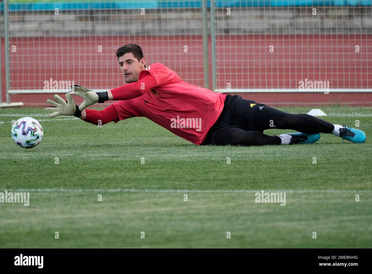 Belgium's goalkeeper Thibaut Courtois dives for a ball during a ...
